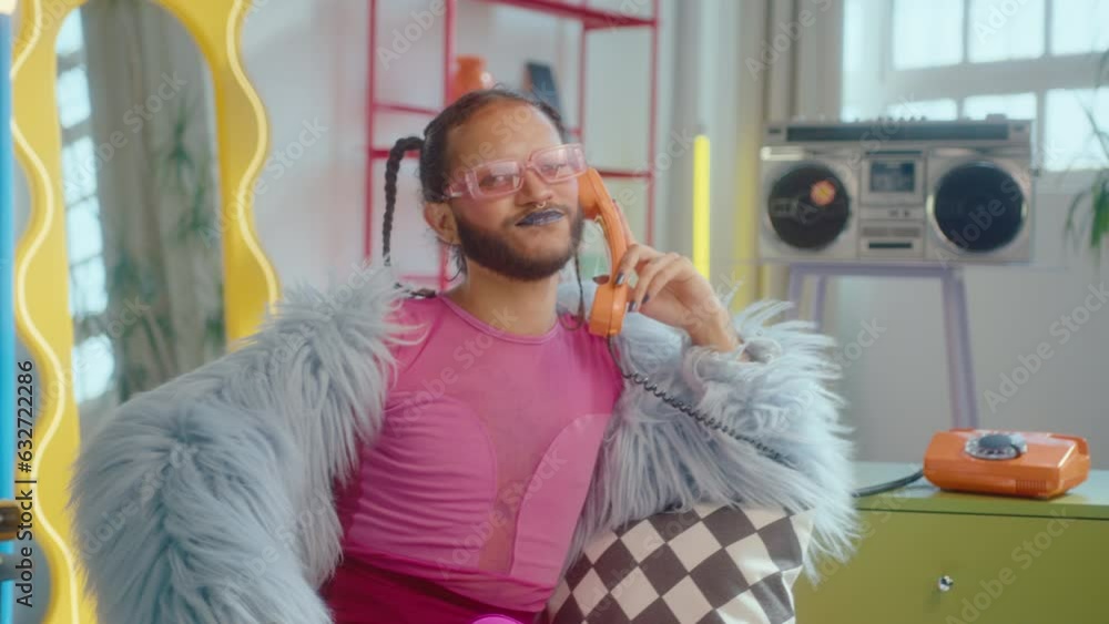 Cross-dressed vogue dancer with beard and pigtails wearing girly outfit ...