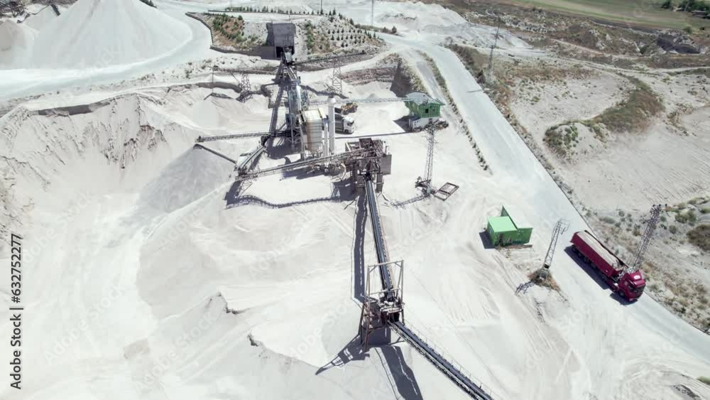 Aerial view of tipper trucks, conveyors, silos and other structures of ...