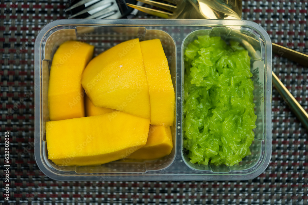 Mango fruit with sweet sticky rice cooked with pandan leave in plastic ...
