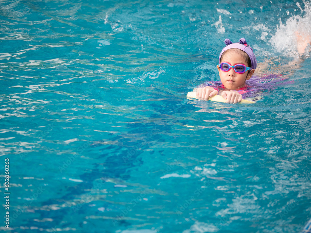 Asian child or kid girl wearing swimming suit to learning on swimming ...