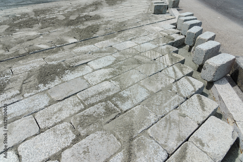 Construction installing and arranging precast concrete pavers stone for ...