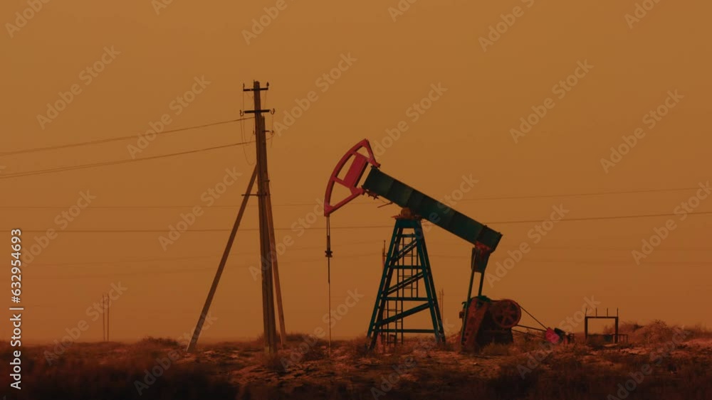 Pumping petroleum Rig in desert at sunset. Oil industry. Pump Jack ...