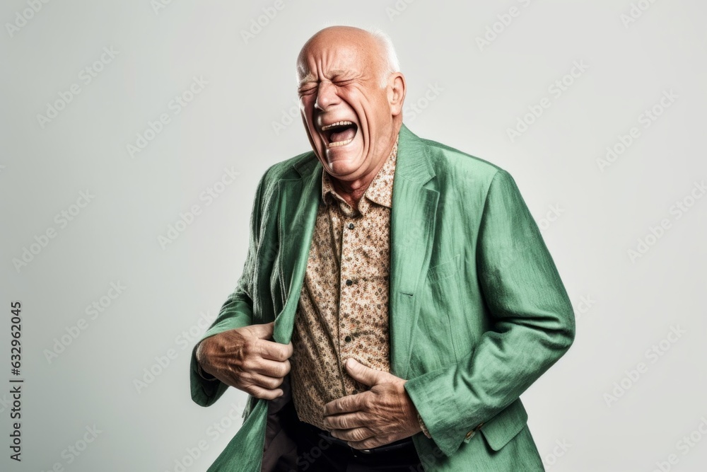Lifestyle portrait photography of a man in his 80s wincing in pain ...