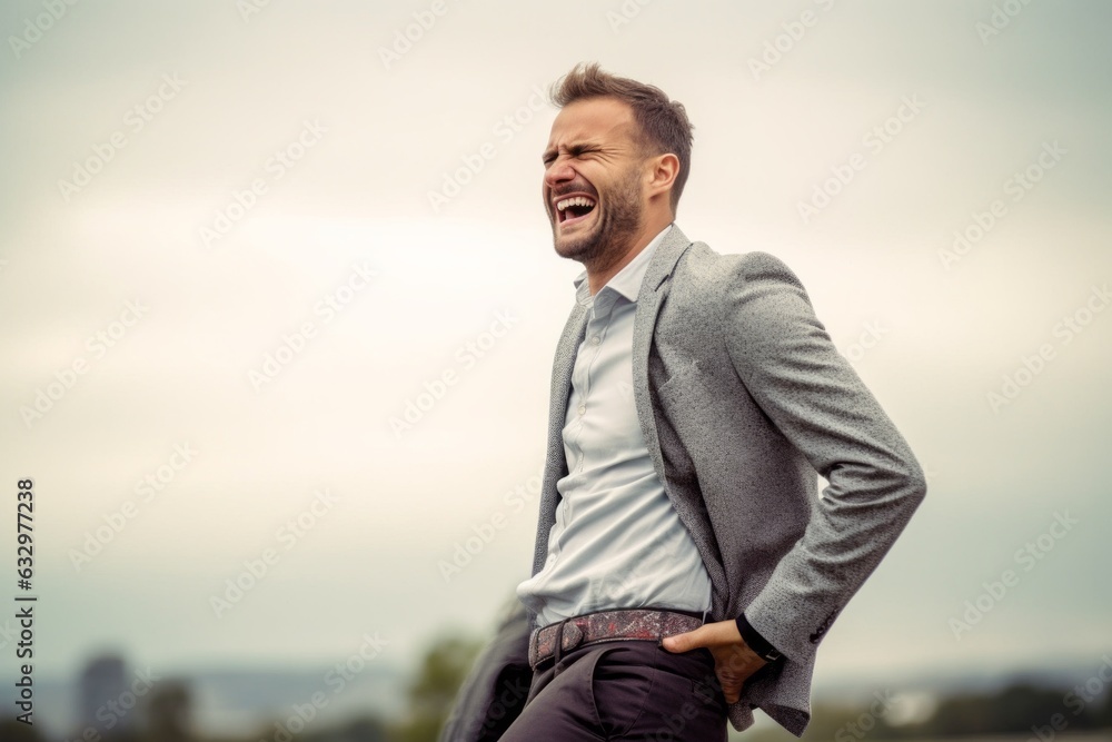 Medium shot portrait photography of a man in his 30s wincing with pain ...