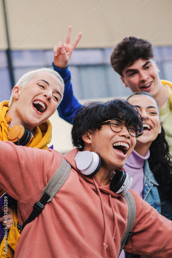 Vertical portrait of a young group of best friends having fun together ...