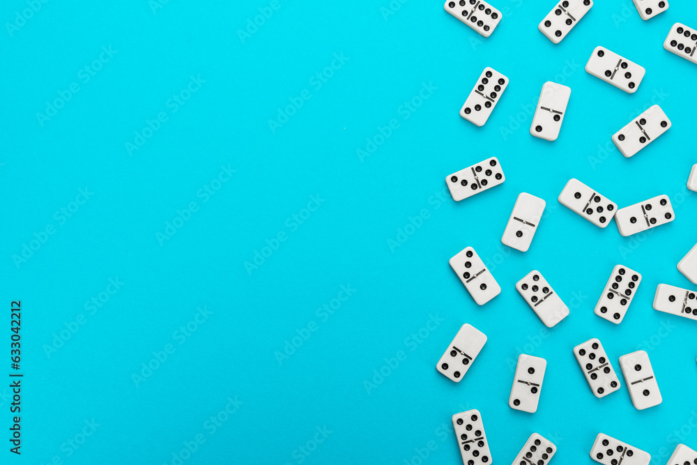 Domino pieces on turquoise blue background with copy space. Flat lay ...