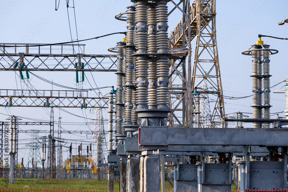 A high-voltage power electrical substation. Power lines, poles, ceramic ...