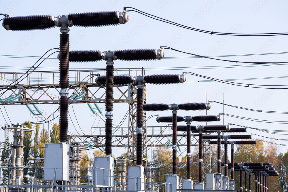 A high-voltage power electrical substation. Power lines, poles, ceramic ...