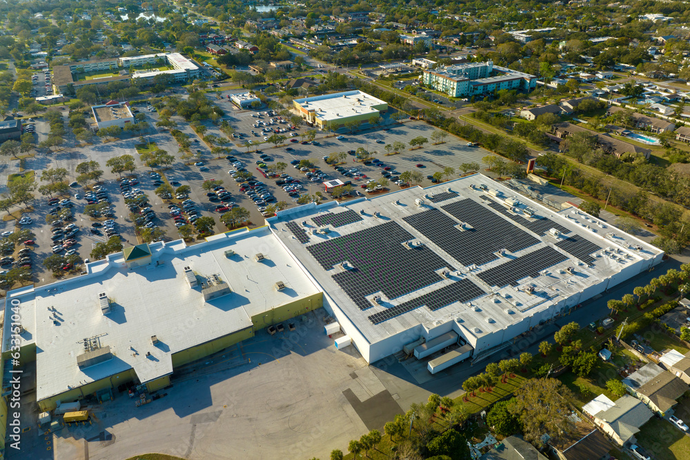 Aerial view of blue photovoltaic solar panels mounted on shopping mall ...