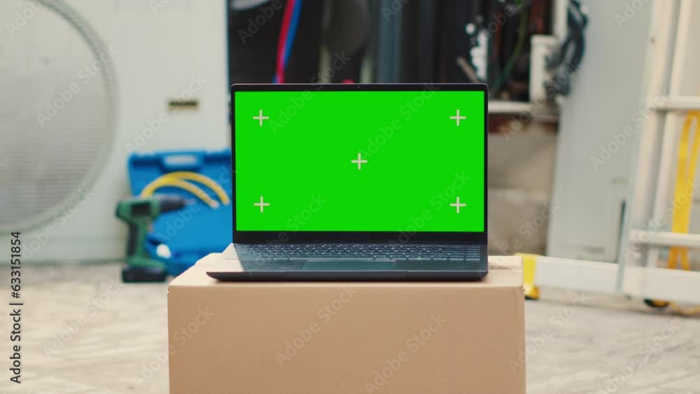 Green screen laptop in front of malfunctioning outdoor condenser. Mock ...