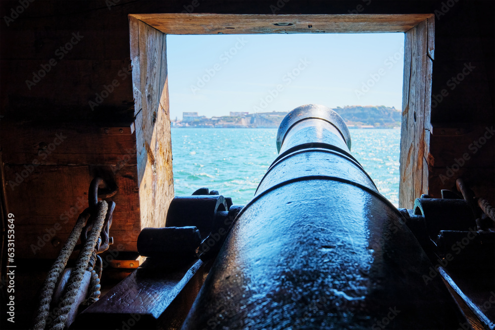 View out of a gunport in hull of the ship on the gun deck over the gun ...