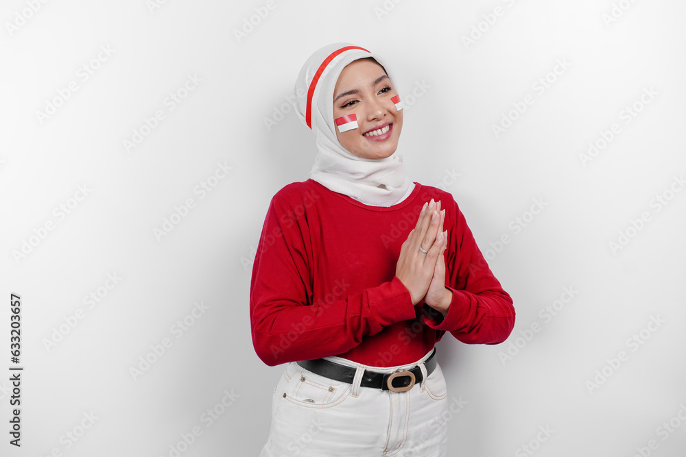 A friendly Indonesian muslim woman is wearing red top and white hijab ...