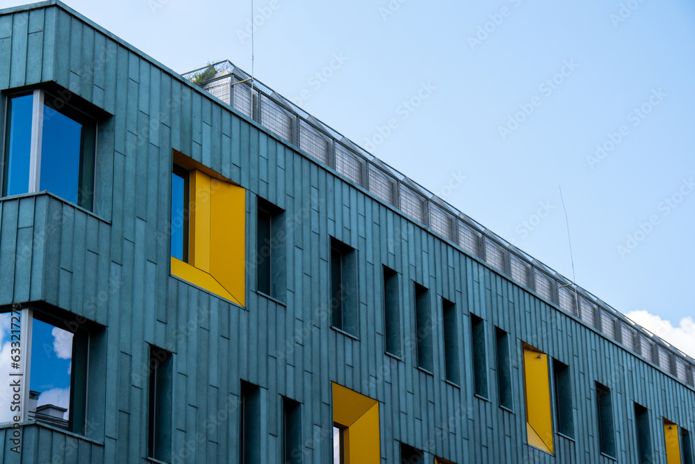 Modern colorful office building exterior with glass facade on clear sky ...