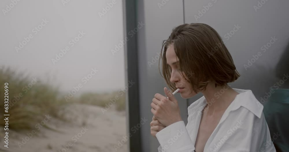 cinematic video of a young and stressed pretty woman smoking a ...