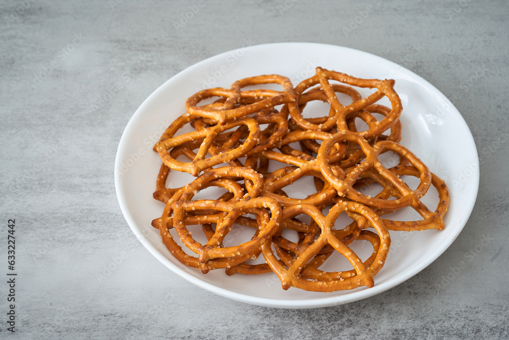salt pretzel in white bowl on table background. pretzel food background ...