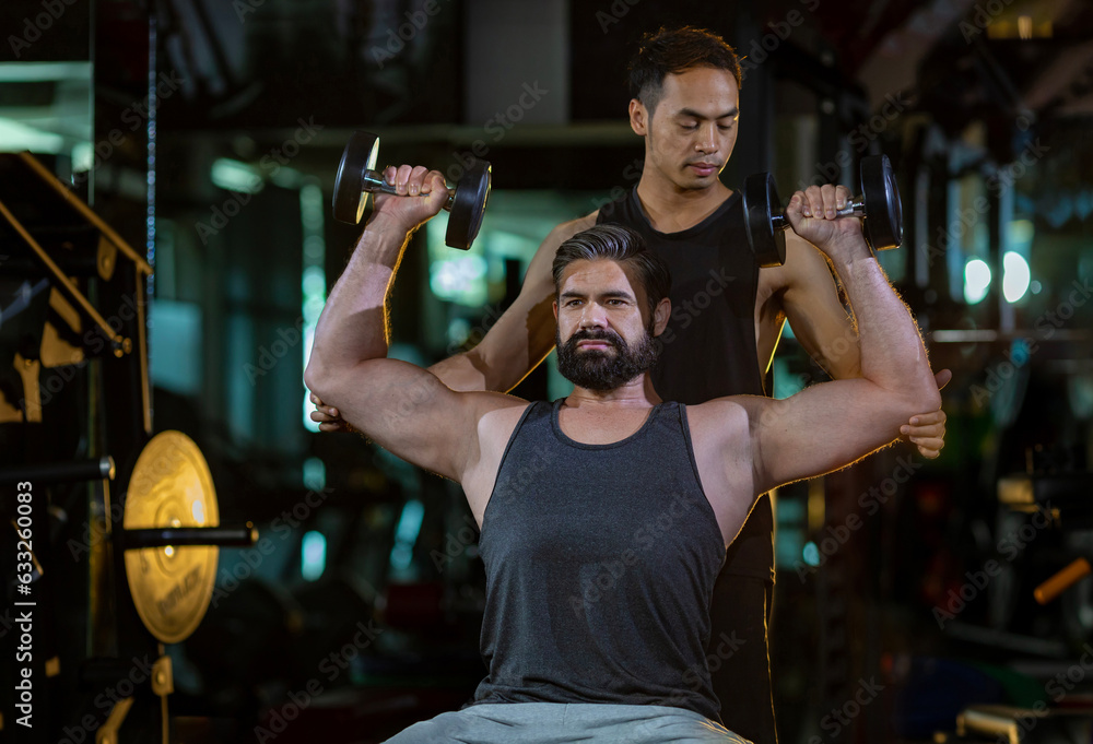 Caucasian man is using dumbbell in weight training for arm muscle ...