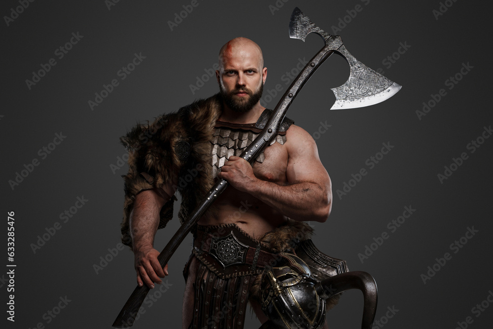 A strong and intimidating Viking man in a beard and bald head, dressed ...