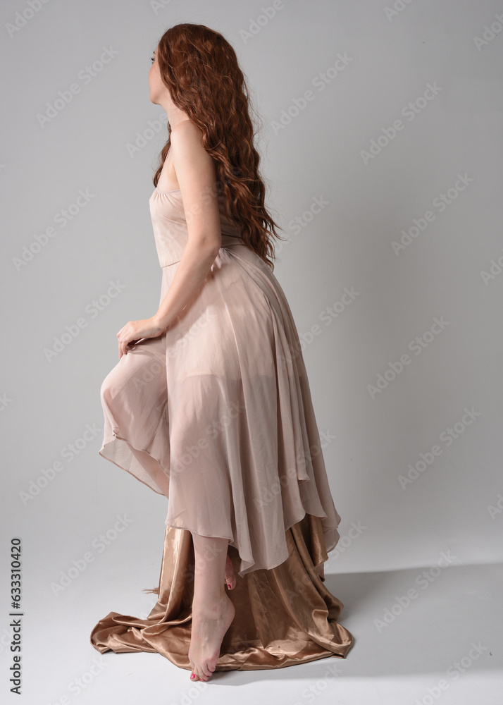 Full length portrait of beautiful female model with long brunette hair ...