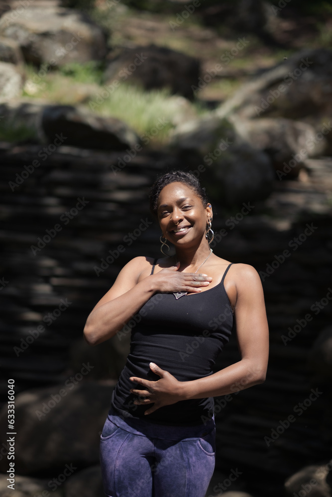 A person has one hand over their chest, another hand over their navel ...