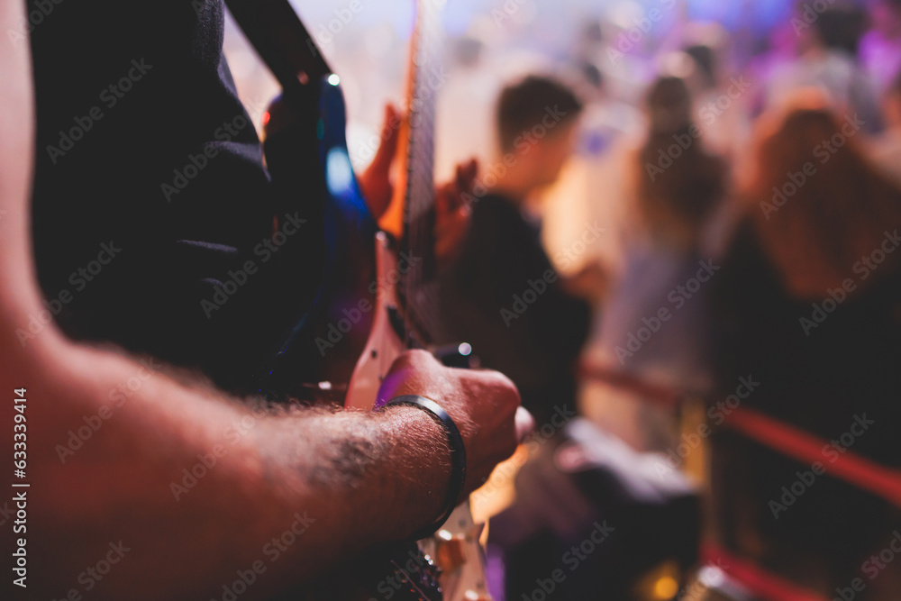 Concert view of an electric guitar player with vocalist and rock band ...