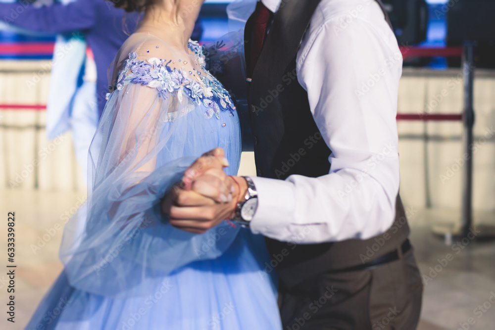 High school graduates dancing waltz and classical ball dance in dresses ...