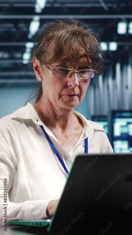 Vertical video Trained mechanic working in high tech facility housing ...