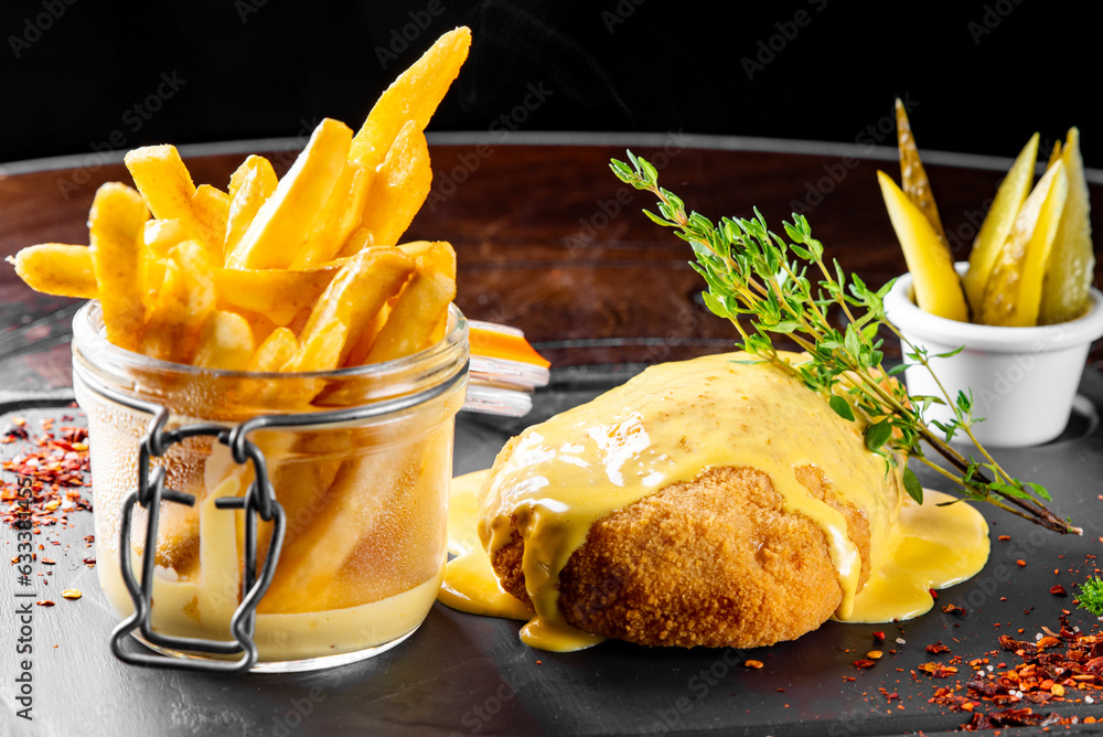 Fried Wiener schnitzel from veal topside with French fries and cheese ...