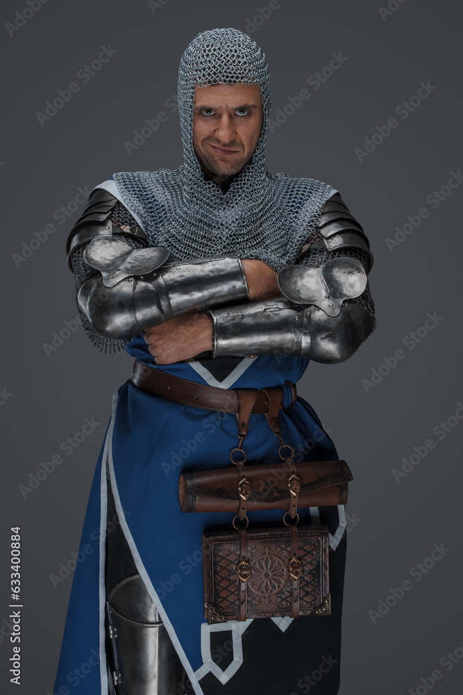 Brave royal guard dressed in medieval armor and blue surcoat, with ...