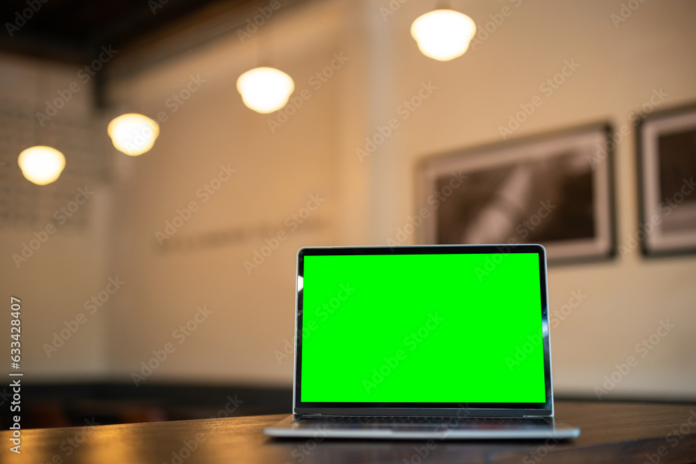 Mockup of laptop computer with empty screen on table side the window in ...