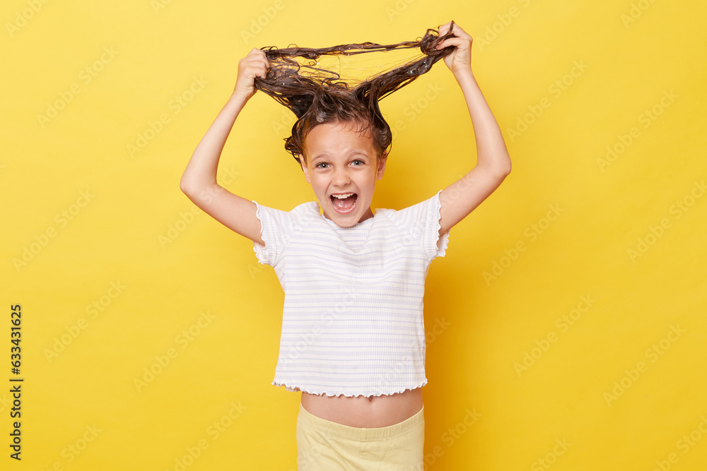 Crazy child girl with shampoo on wet hair wearing white T-shirt ...