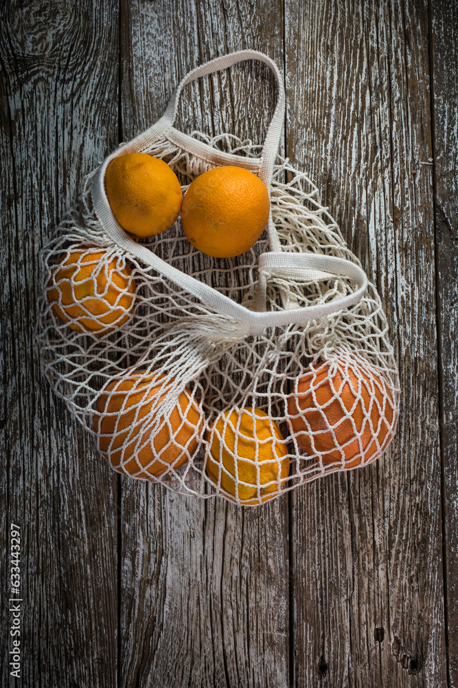 Oranges in a mesh bag. Stock Photo | Adobe Stock