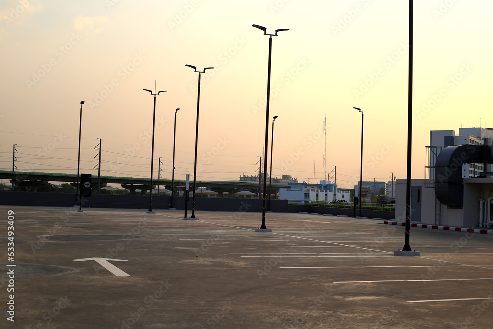 white clouds blue sky sunset Rooftop parking lot with lamp post ...