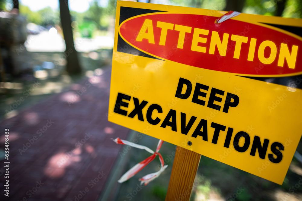 Beware of deep excavations - plastic warning sign posted on the ...