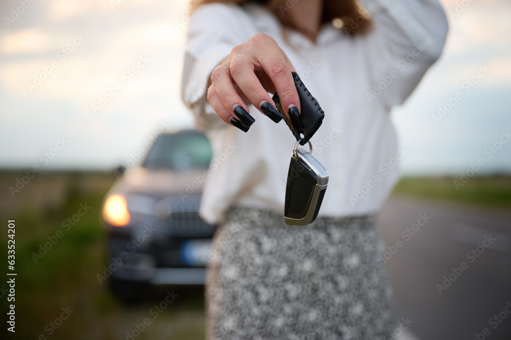 Yung beautiful happy girl holds the keys to a new car in her hand ...