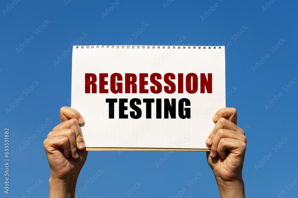 Regression testing text on notebook paper held by 2 hands with isolated ...