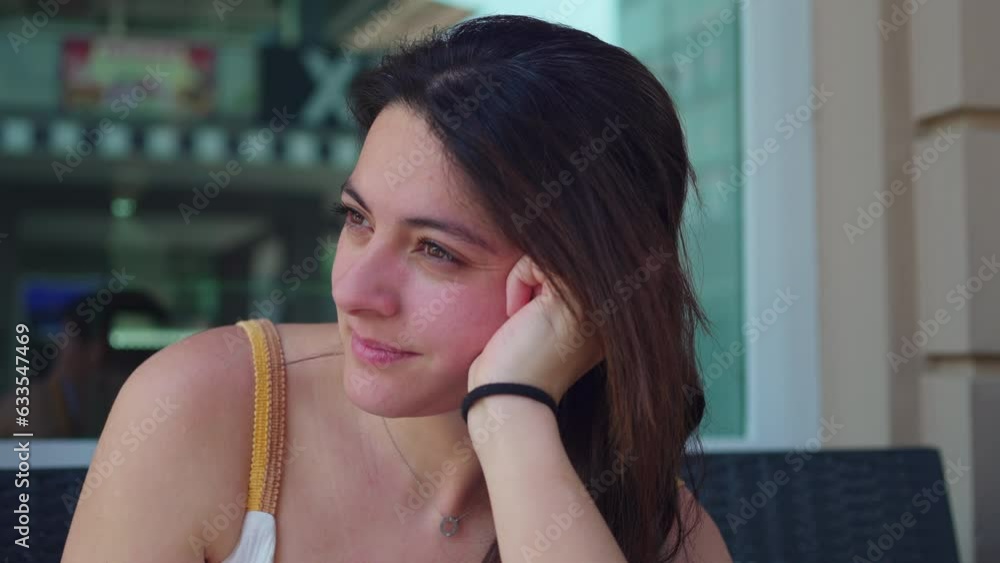 Pensive woman close-up face seated outside by coffee shop gazing at ...
