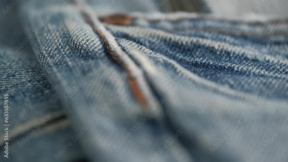 rotation of details of jeans trim closeup. metal rivets on pockets of ...