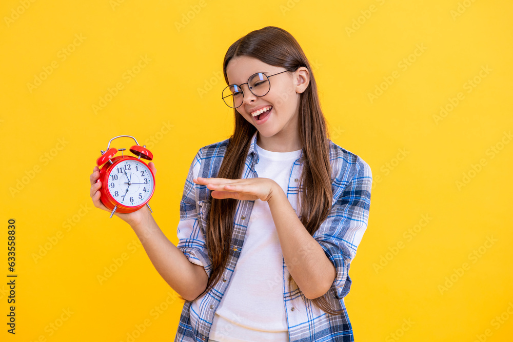 Teen girl hold alarm clock. school time. Teen girl checking the clock ...