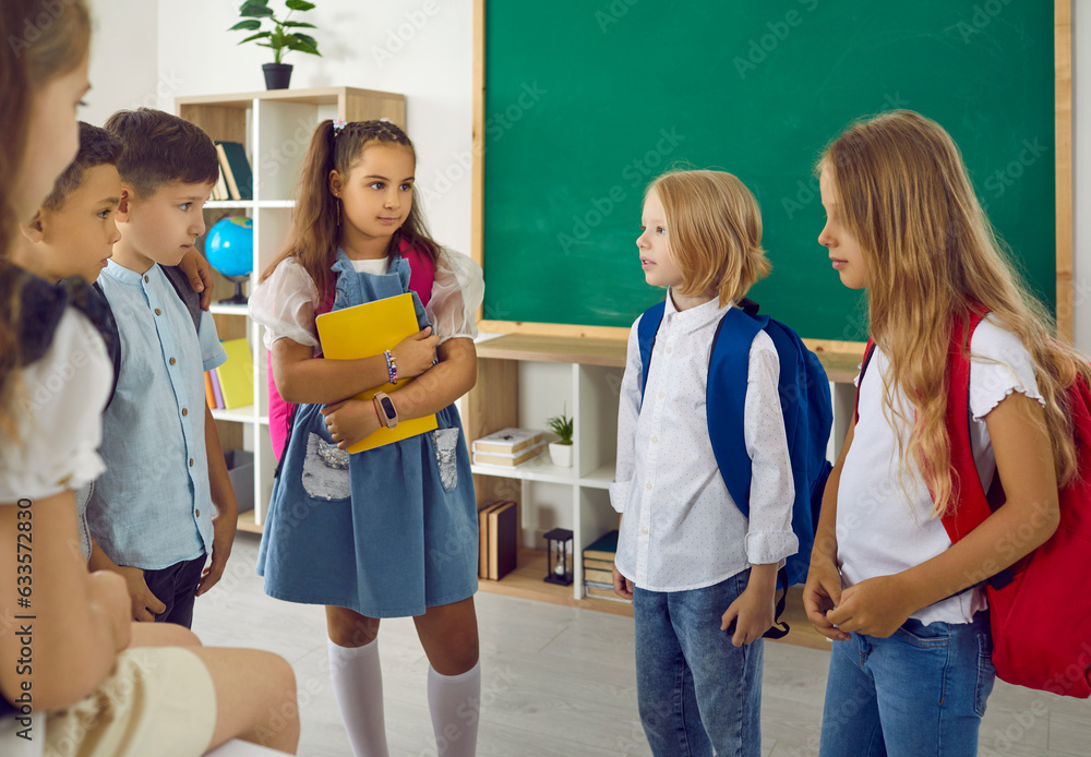 Group of shy kids standing in the classroom. Children come to school ...