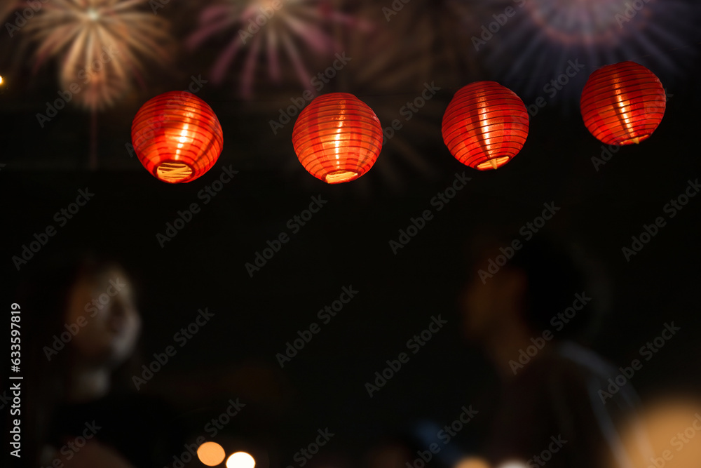 Japanese festival scene with lanterns and fireworks in the distance ...