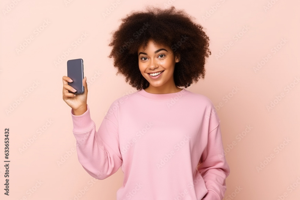 Happy African American teen student holding mobile cell phone pointing ...