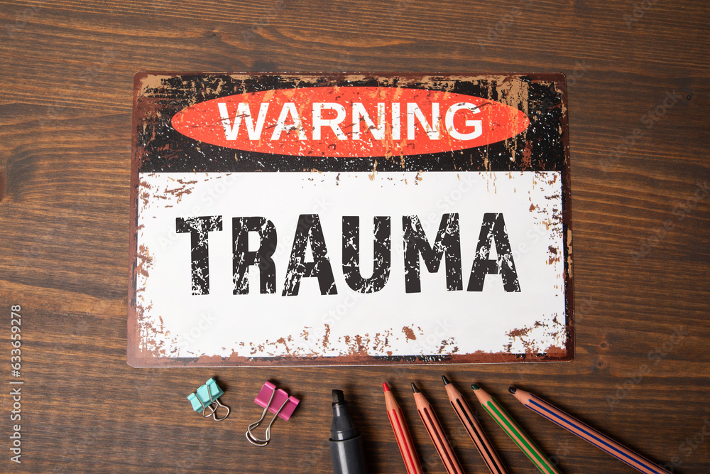 TRAUMA. Warning sign with text on wood texture background Stock Photo ...