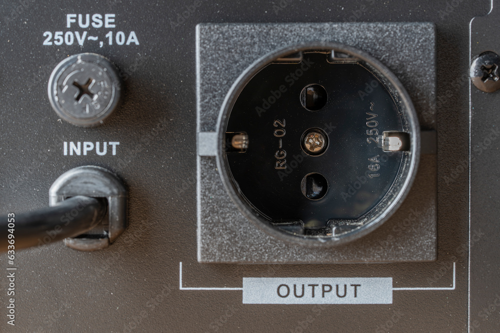 Electrical socket output and input cable on the back of the ...