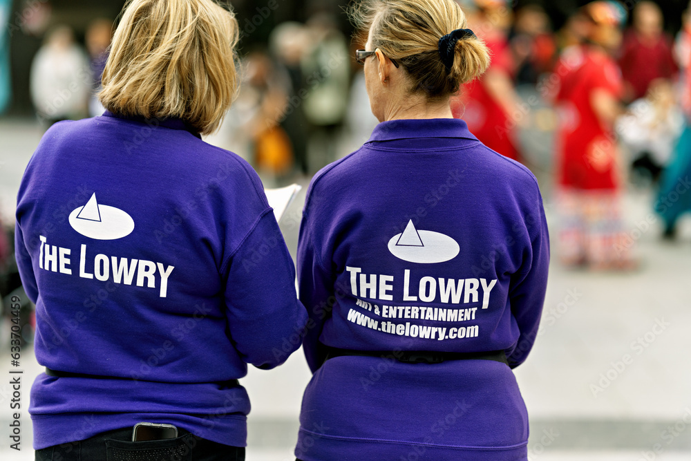 The Lowry theatre employee's stand outside chatting with the brand logo ...