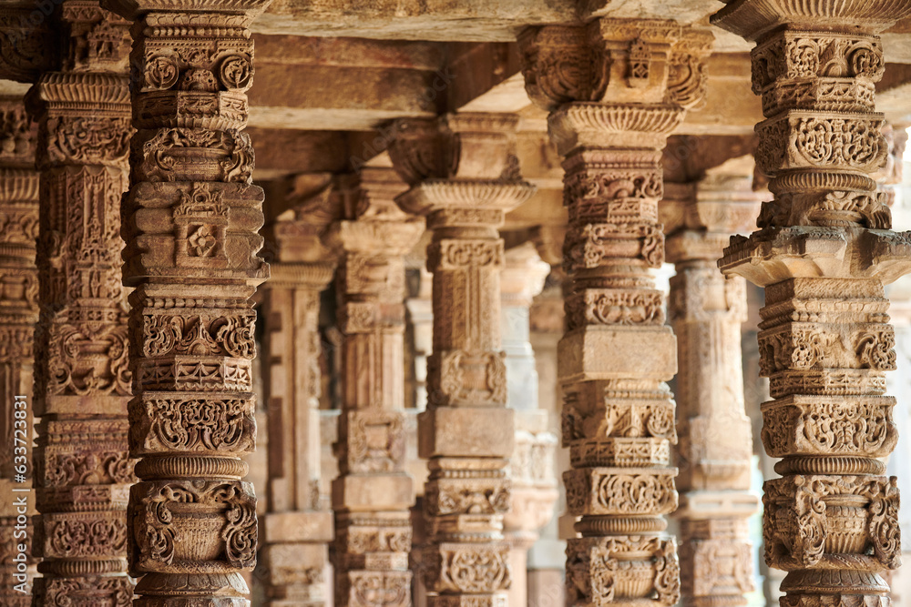 Stone columns with decorative bas relief of Qutb complex in South Delhi ...