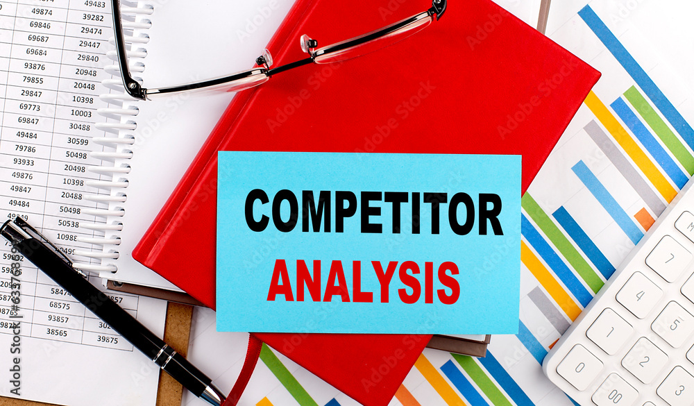 COMPETITOR ANALYSIS text on a sticky on red notebook on chart ...