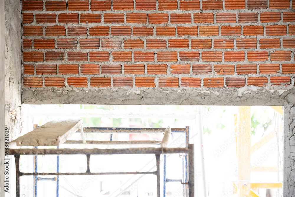 Bricks wall and cement background.Scaffolding and bricks wall on work ...