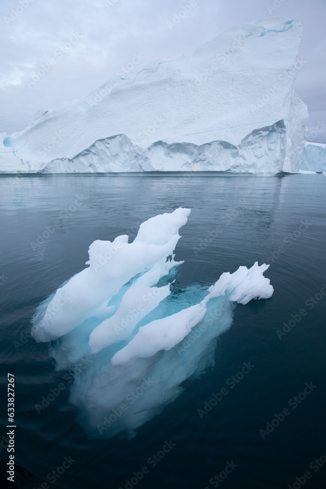 Melting of a iceberg and pouring water into the sea by the coast of ...