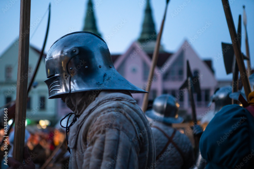 Medieval knights in metal armour and helmet wuth a spear during ...