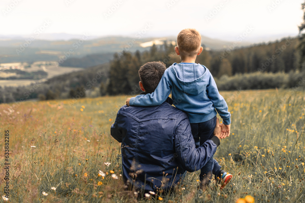family father and son bonding in a scenic field with love and ...